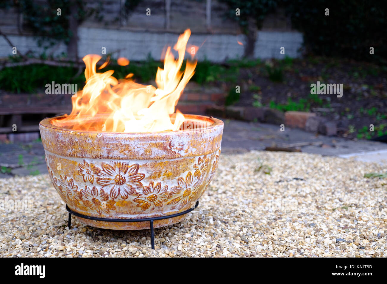 A clay outdoor fire pit in back garden in cold autumn evening Stock ...