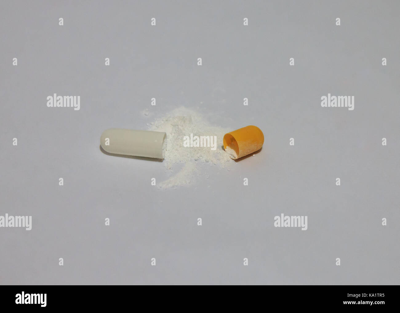 close up of open capsule and powder on white background Stock Photo - Alamy
