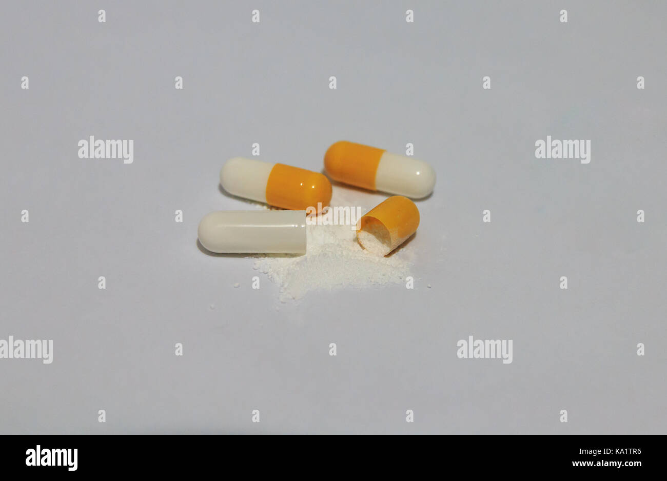 close up of open capsule and powder on white background Stock Photo - Alamy