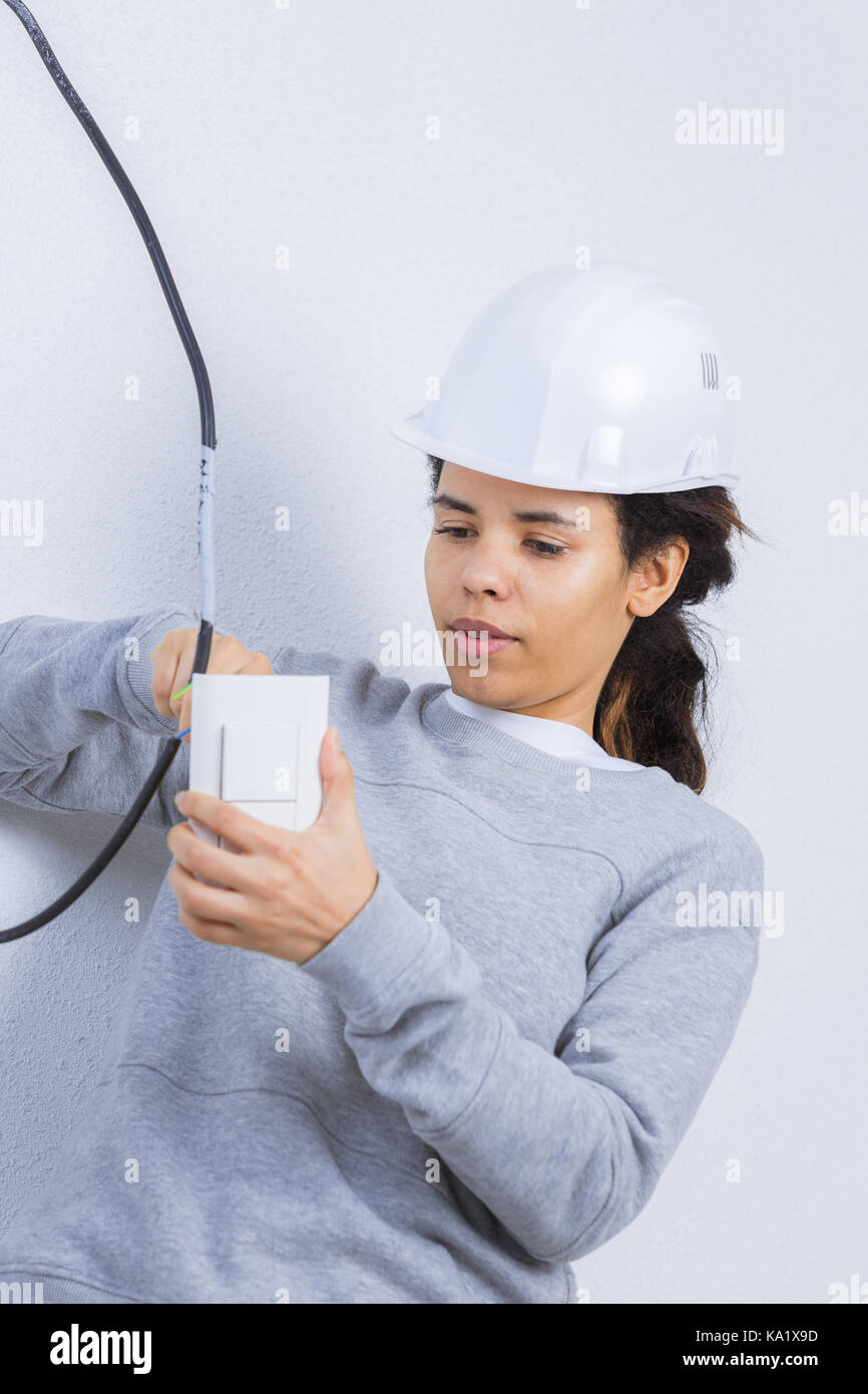woman fitting an electrical outlet in bathroom Stock Photo - Alamy