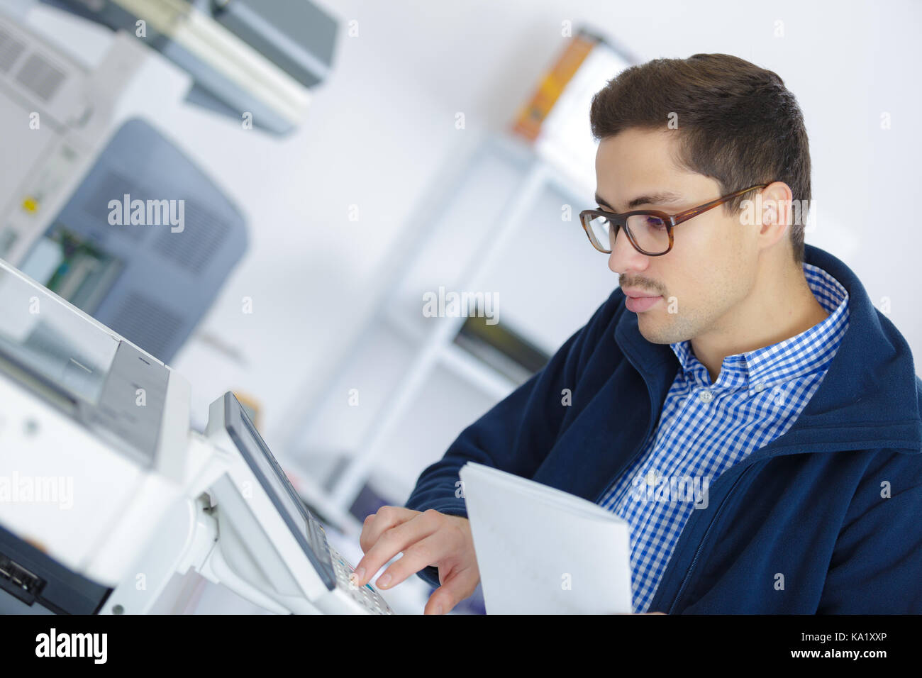 fixing a printer machine at a business place Stock Photo - Alamy