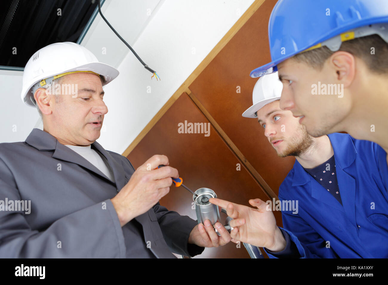 professional cctv technician working with apprentice Stock Photo - Alamy