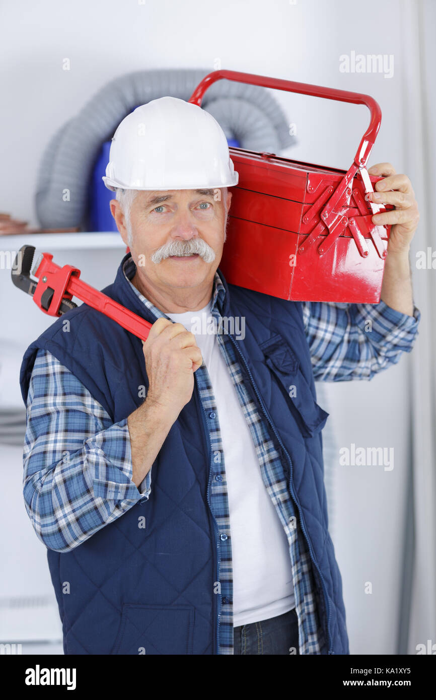 Handyman is holding a wrench and a toolbox hi-res stock photography and images - Alamy