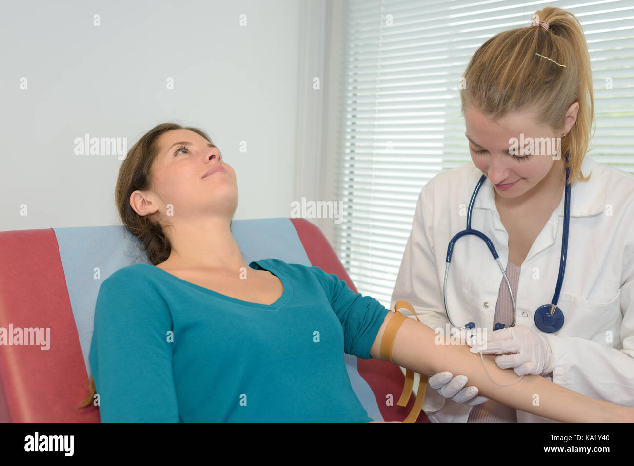 doctor taking blood of her smiling patient Stock Photo - Alamy