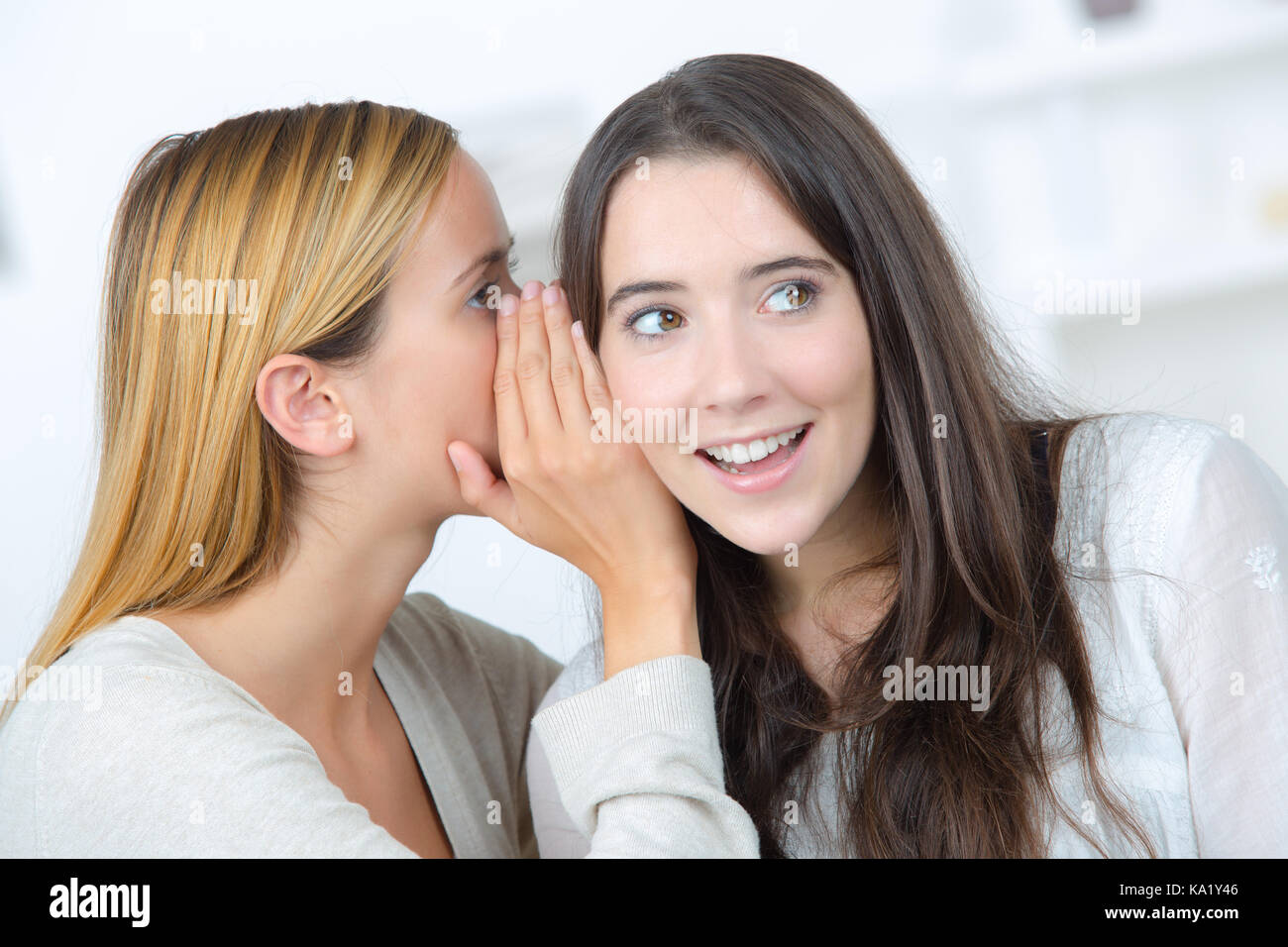 two girls gossiping Stock Photo - Alamy