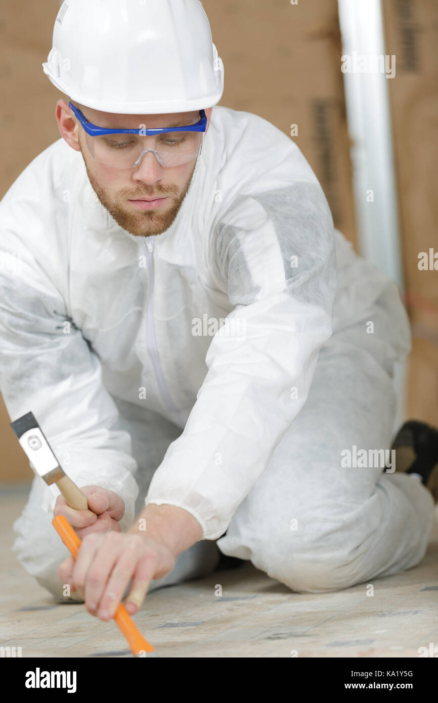 builder removing plaster Stock Photo - Alamy