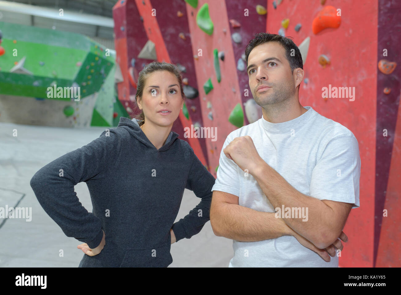 woman and boyfriend at rock climbing wall at gym Stock Photo - Alamy