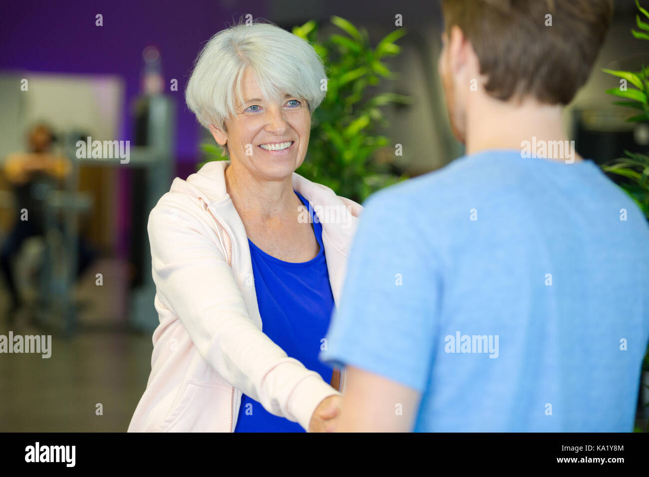 greeting the elderly woman Stock Photo - Alamy
