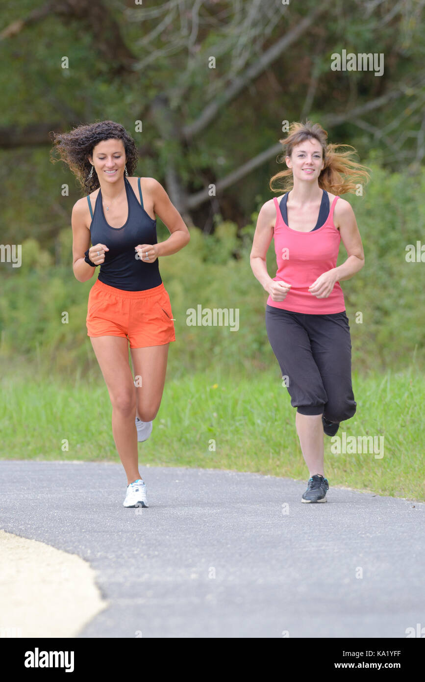 smiling friends running outdoors Stock Photo - Alamy