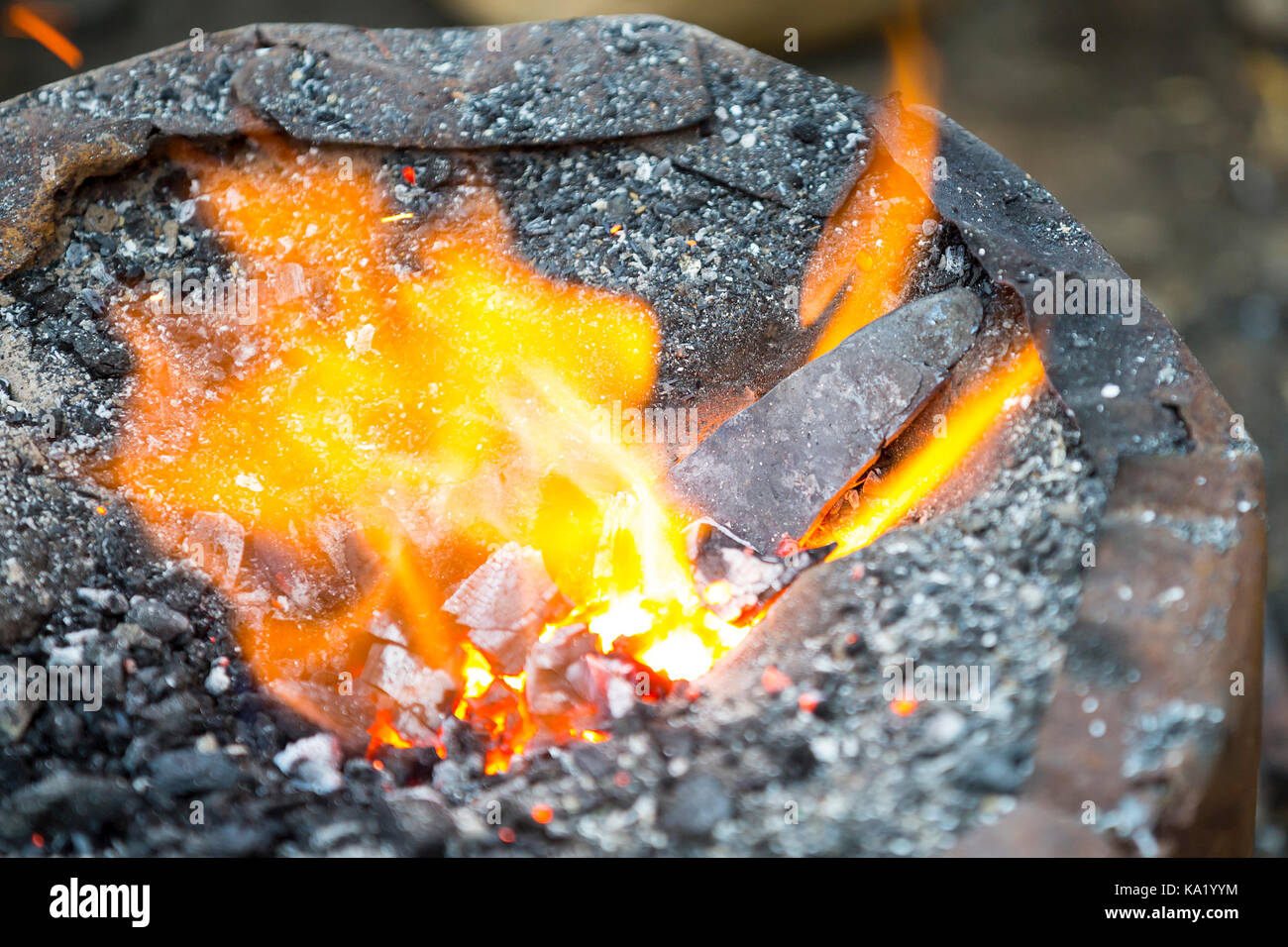 Hot metal arrow blade in the fire before being hammered by a blacksmith ...
