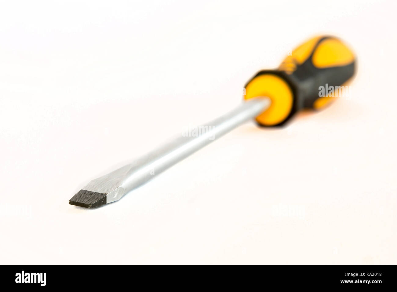 Screwdriver with rubber black and yellow handles isolated on a white ...
