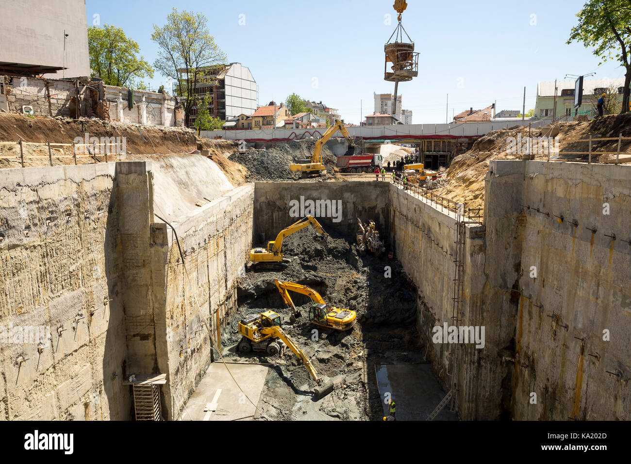 Excavators dig at a construction site of a street and a subway. Baggers ...