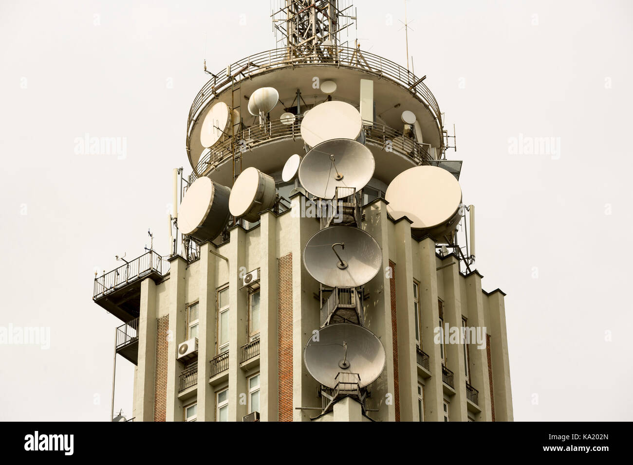 Old television broadcast tower with satellite dishes and communication ...