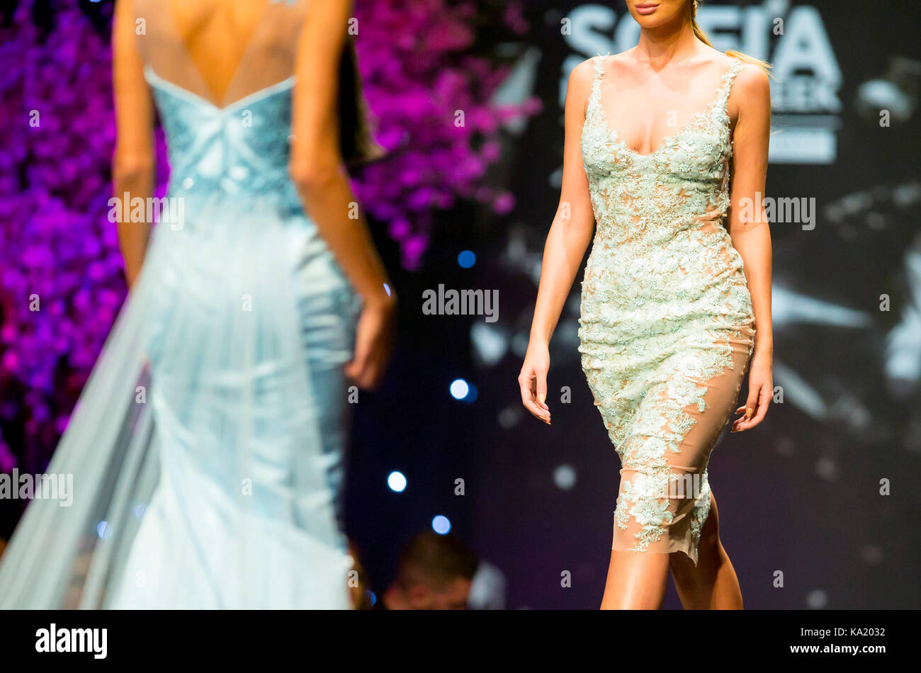 A female model walks the runway in stylish green with flowers dress ...