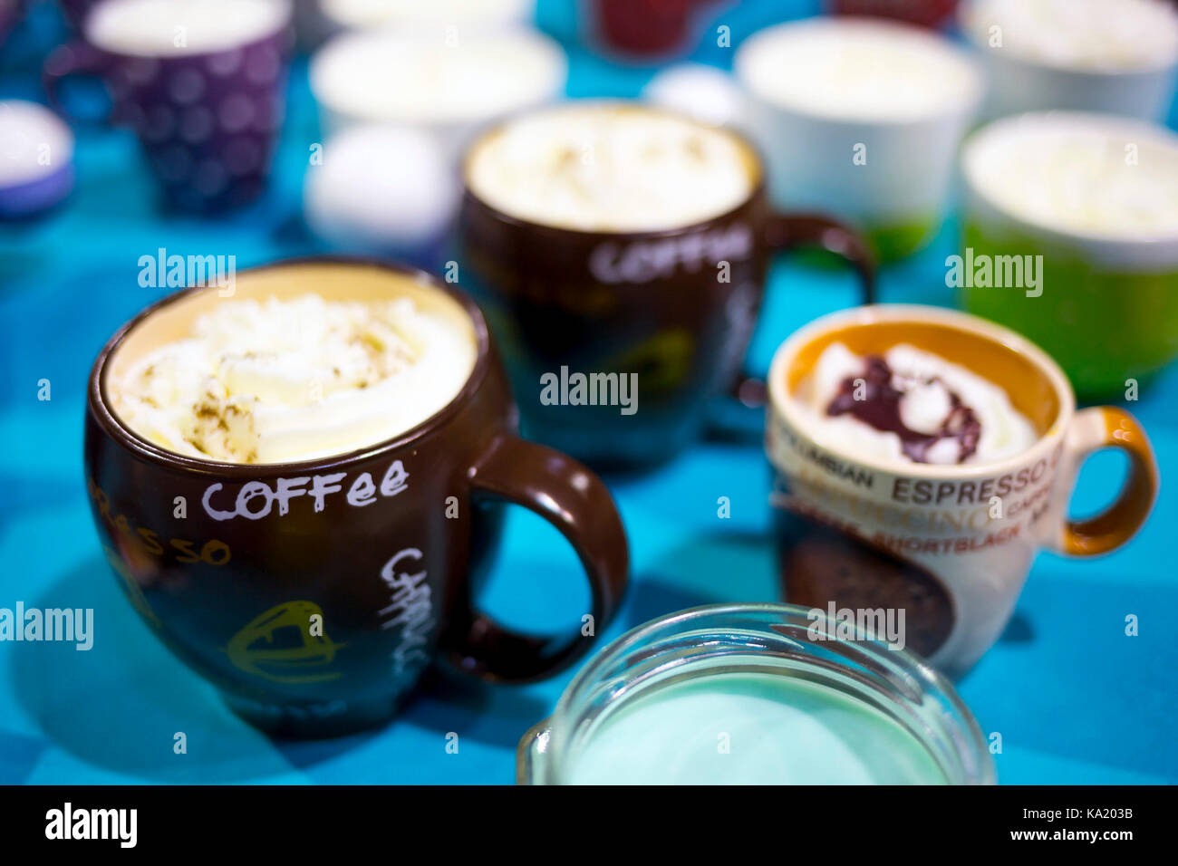 Cups of coffee with cream on top. Espresso latte with cinnamon and ...