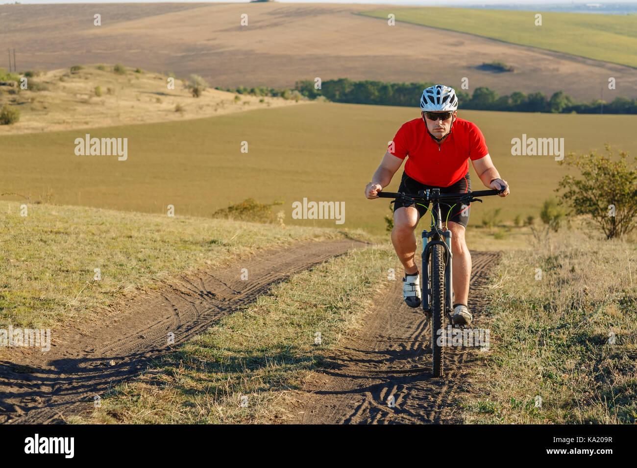 Bike adventure travel photo. Bike tourist rides on the country road ...