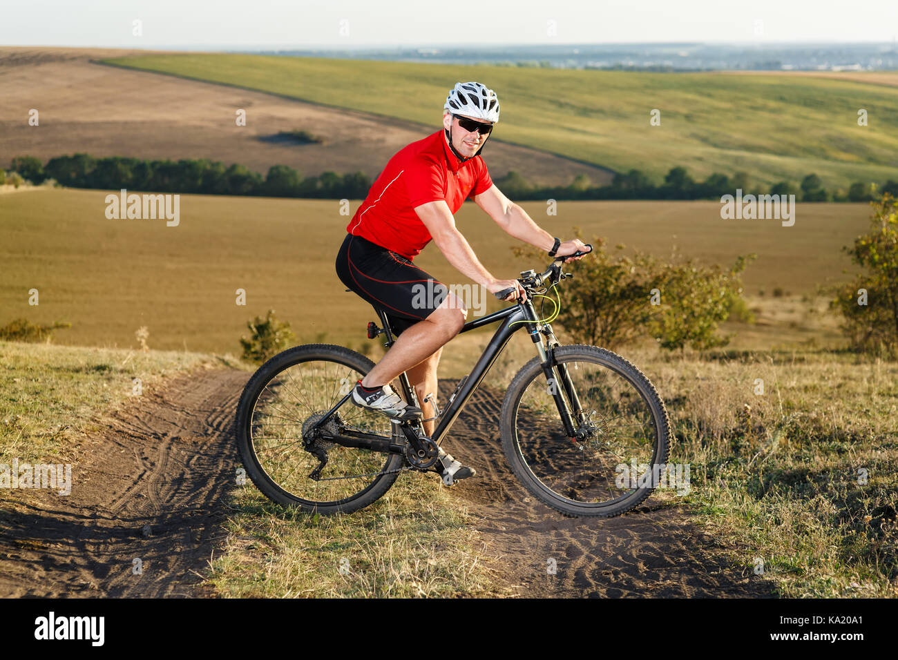 Bike adventure travel photo. Bike tourist rides on the country road ...