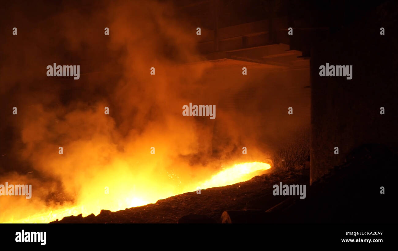 Liquid metal from blast furnace. Liquid metal pouring stream Stock ...
