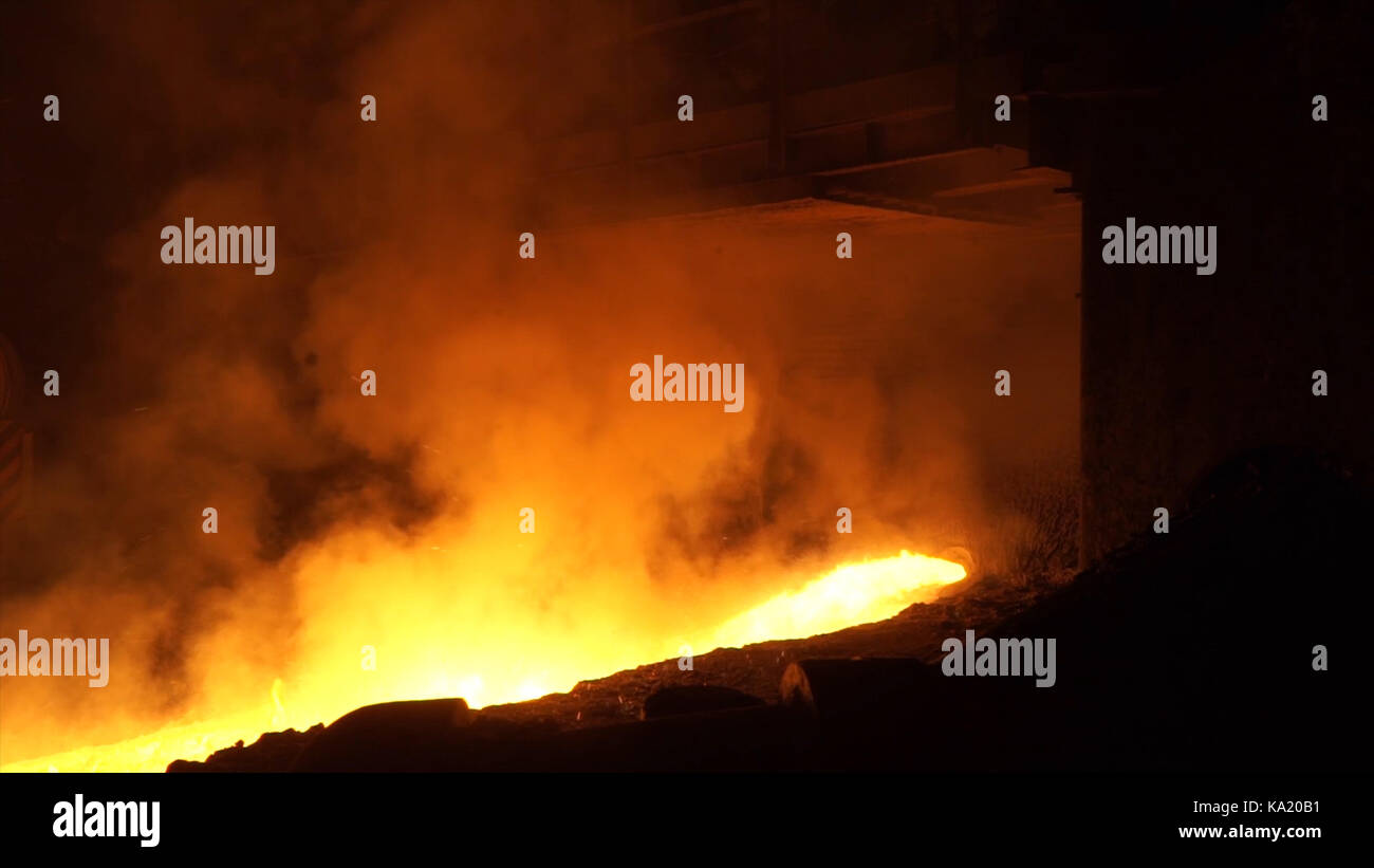 Liquid metal from blast furnace. Liquid metal pouring stream Stock ...