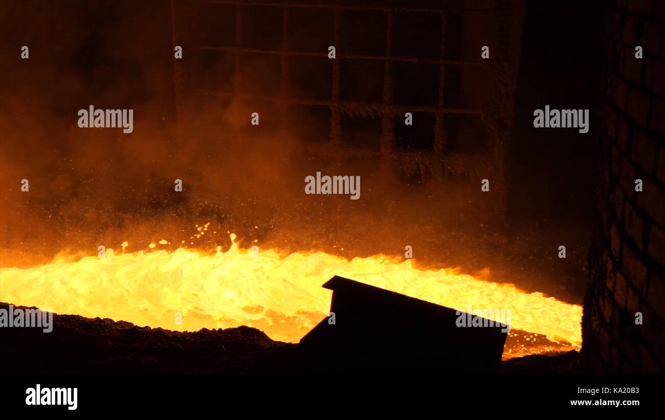 Liquid metal from blast furnace. Liquid metal pouring stream Stock ...