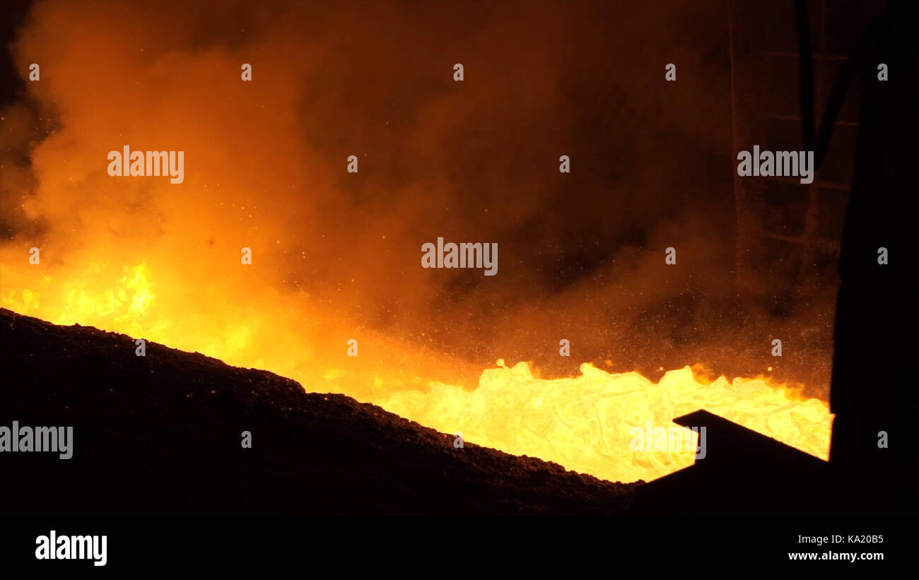 Liquid metal from blast furnace. Liquid metal pouring stream Stock ...