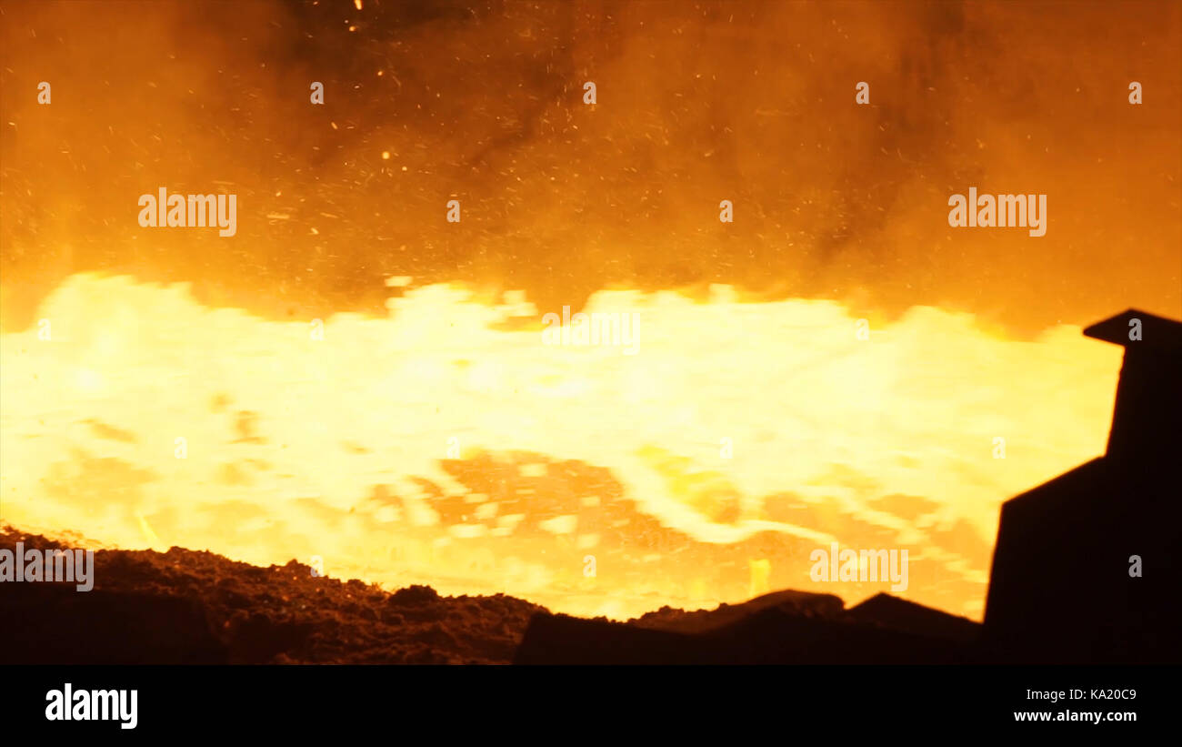 Pouring of liquid metal in open-hearth furnace. Hot steel pouring ...