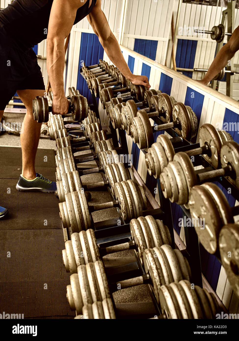 Man in gym workout with fitness equipment. Cropped shot Stock Photo - Alamy