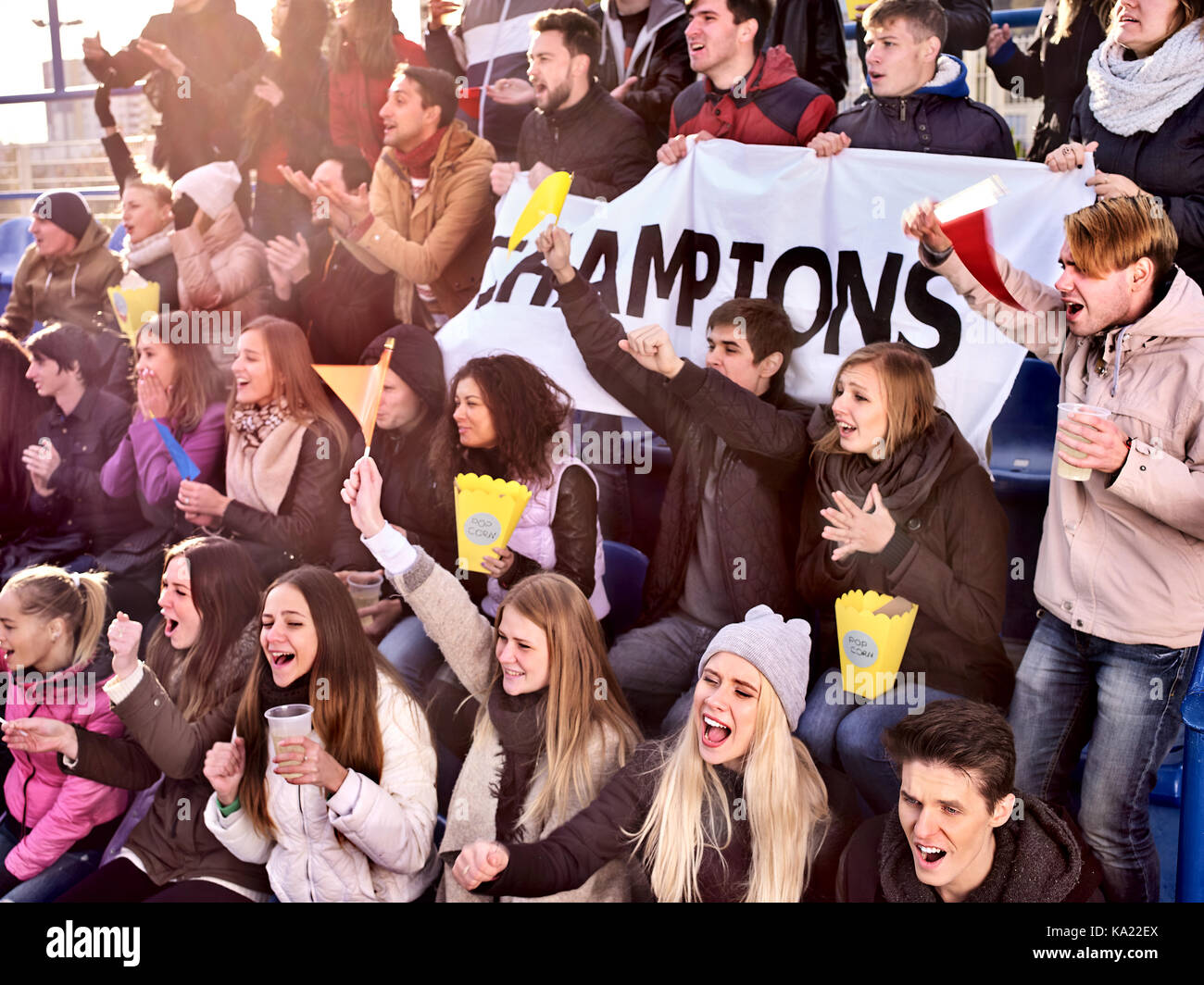 Cheering fans in stadium holding champion banner Stock Photo - Alamy