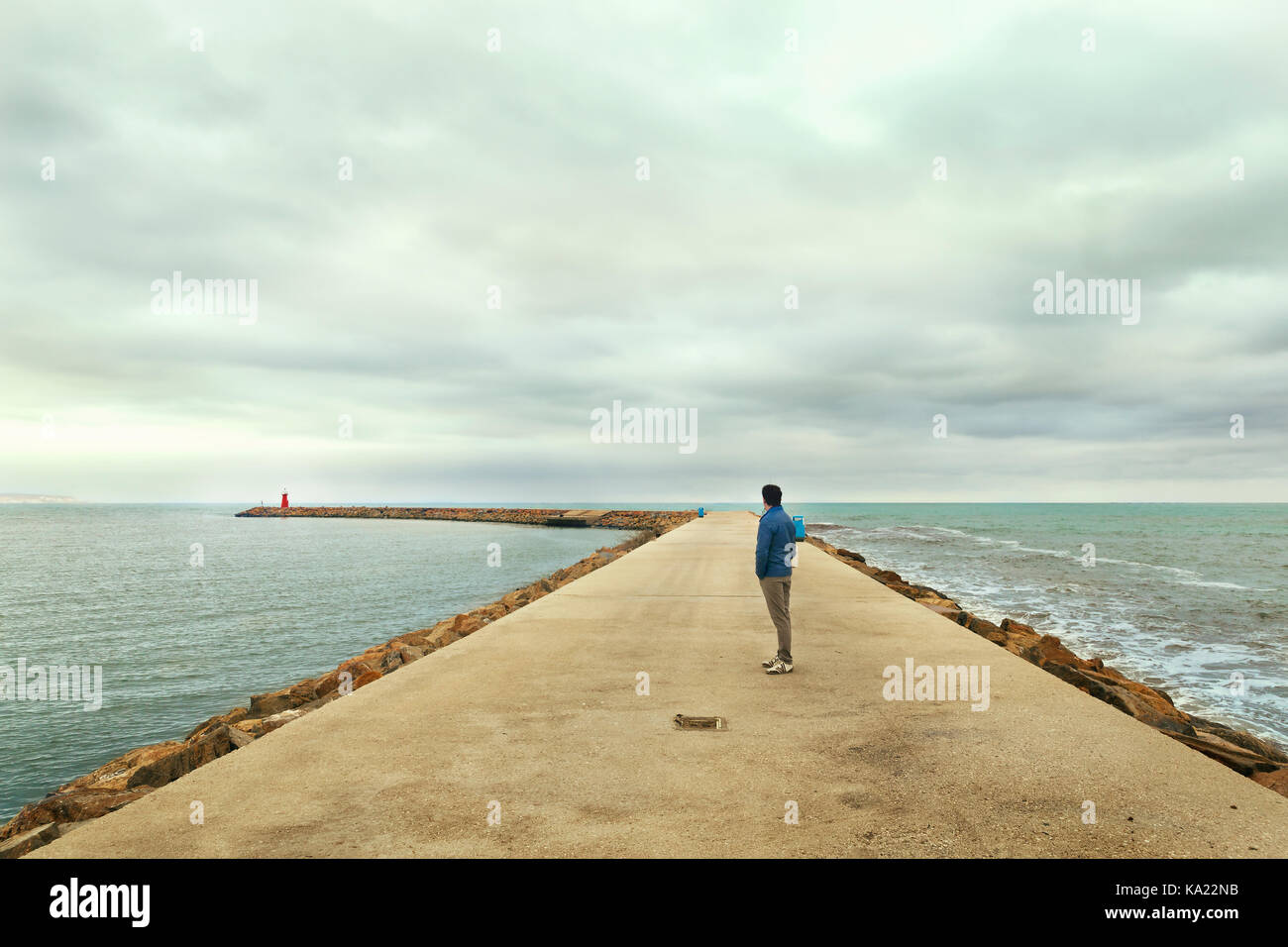 landscape with a man observing the sea horizon and lighthouse in the ...