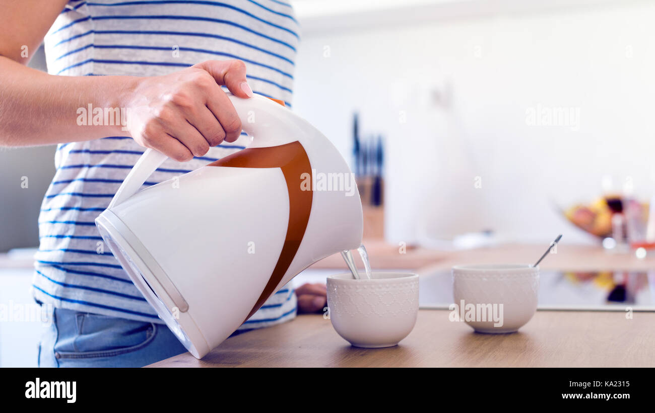 Two cups and pouring tea hi-res stock photography and images - Alamy