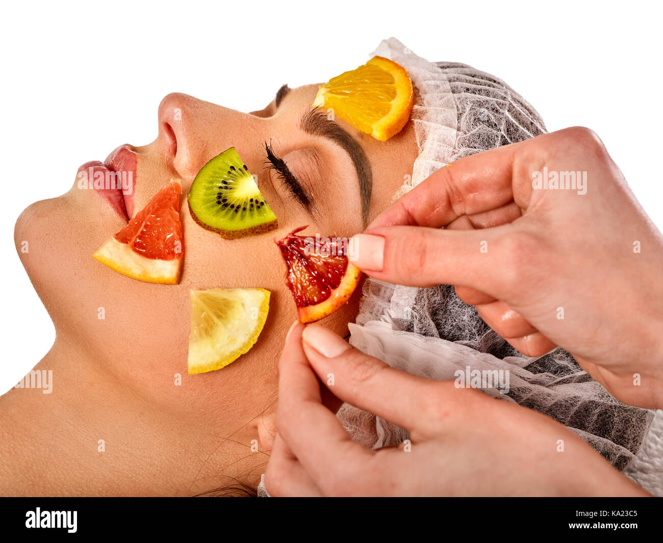 Facial mask from fresh fruits for woman . Beautician apply slices Stock ...