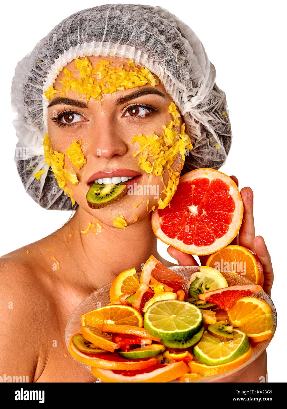 Facial mask from fruits for woman . Girl in medical hat Stock Photo - Alamy