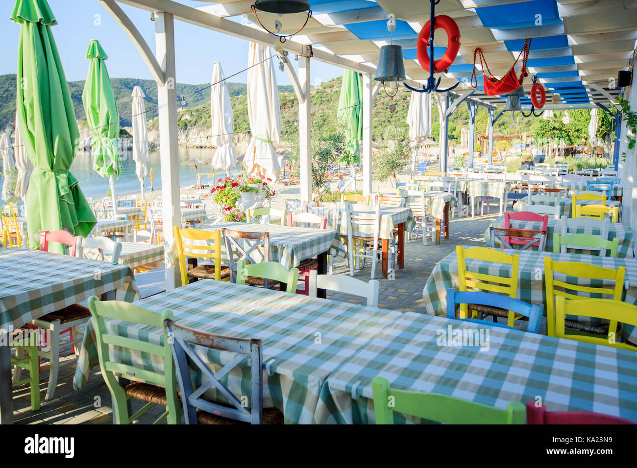 Greek taverna tables on the beach , traditional restaurant in the ...