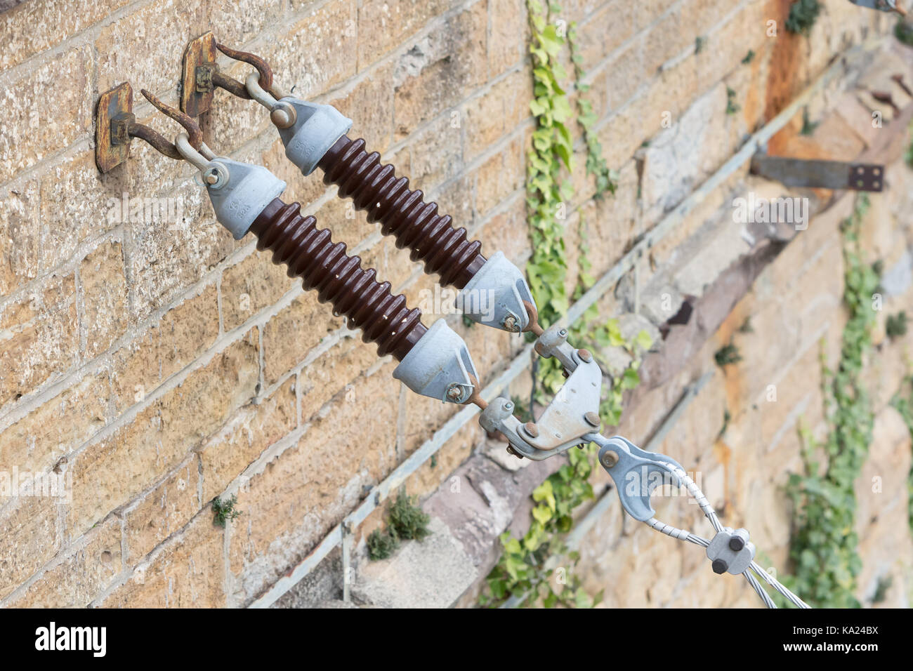 Ceramic insulation for electric cable hanging on an old wall Stock ...