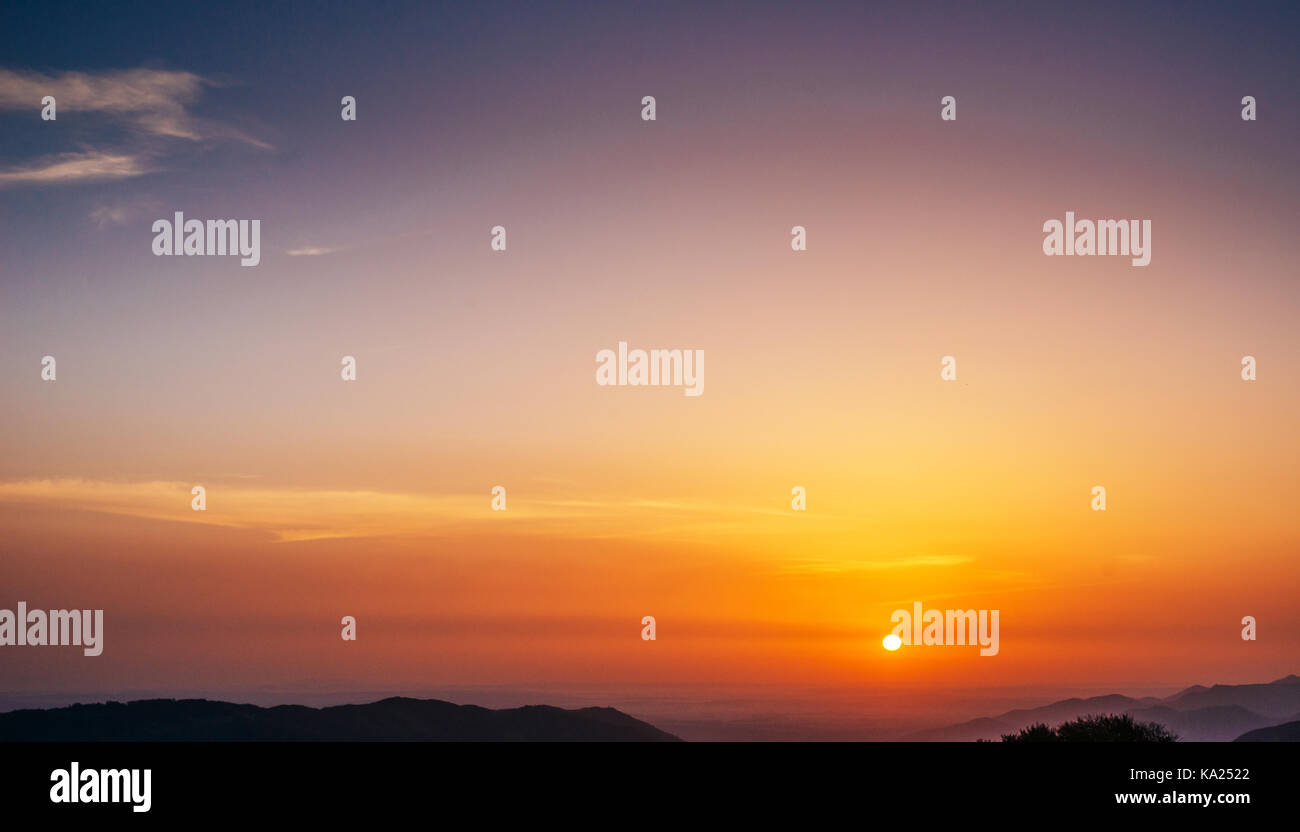 Sunset with sun rays, sky with clouds and sun Stock Photo - Alamy