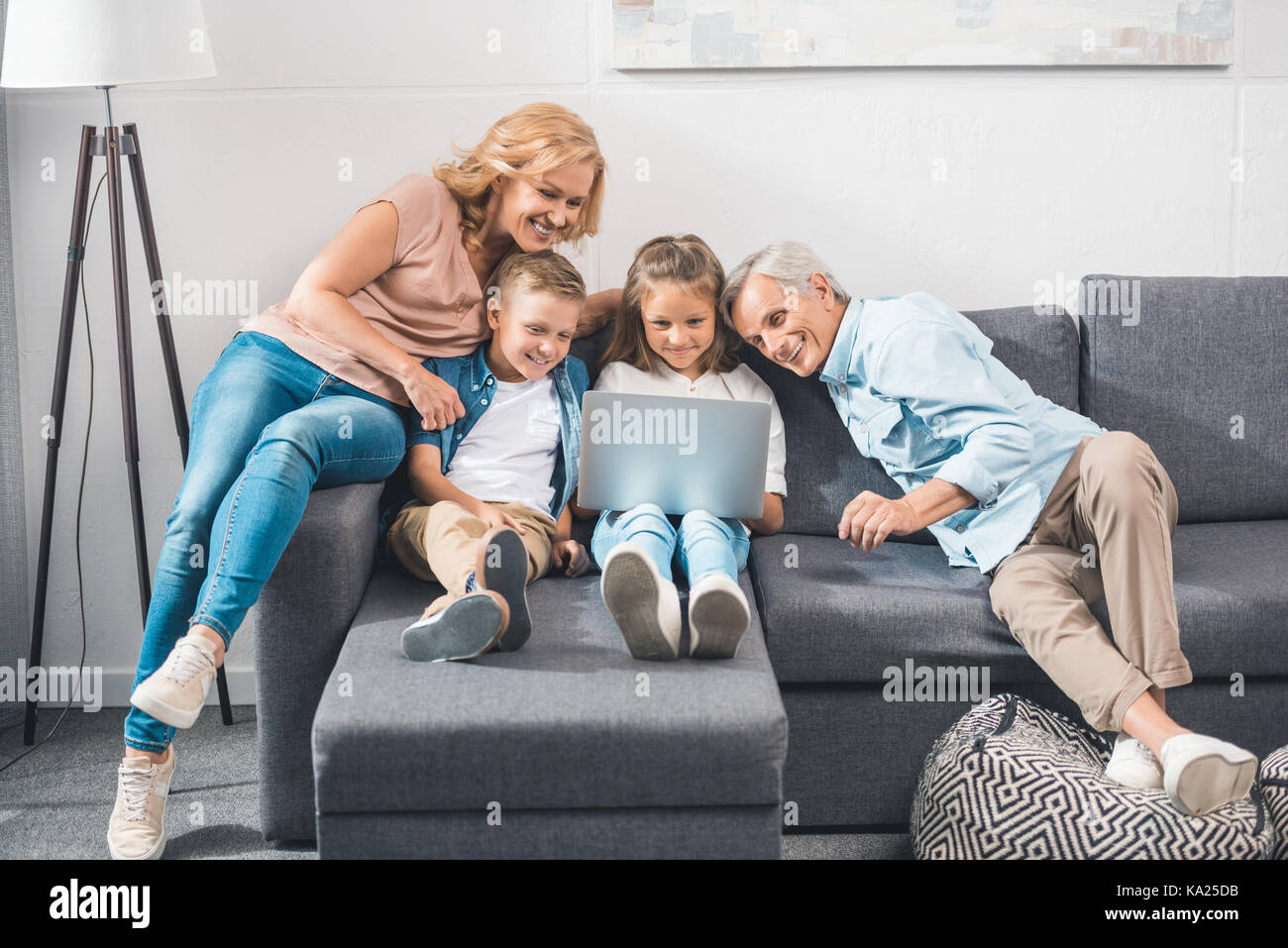 family using laptop Stock Photo - Alamy