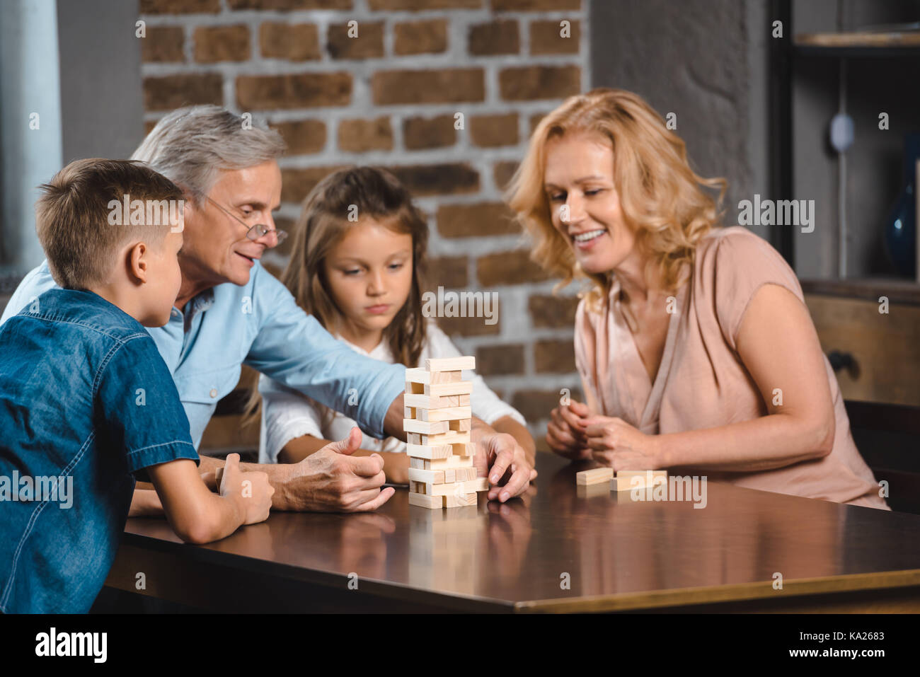 family playing blocks wood game Stock Photo - Alamy