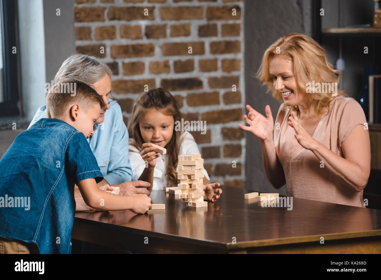 family playing blocks wood game Stock Photo - Alamy