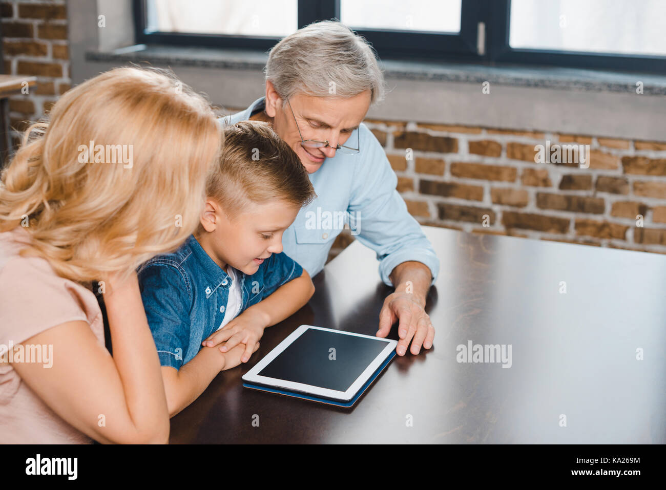 family using digital tablet Stock Photo - Alamy