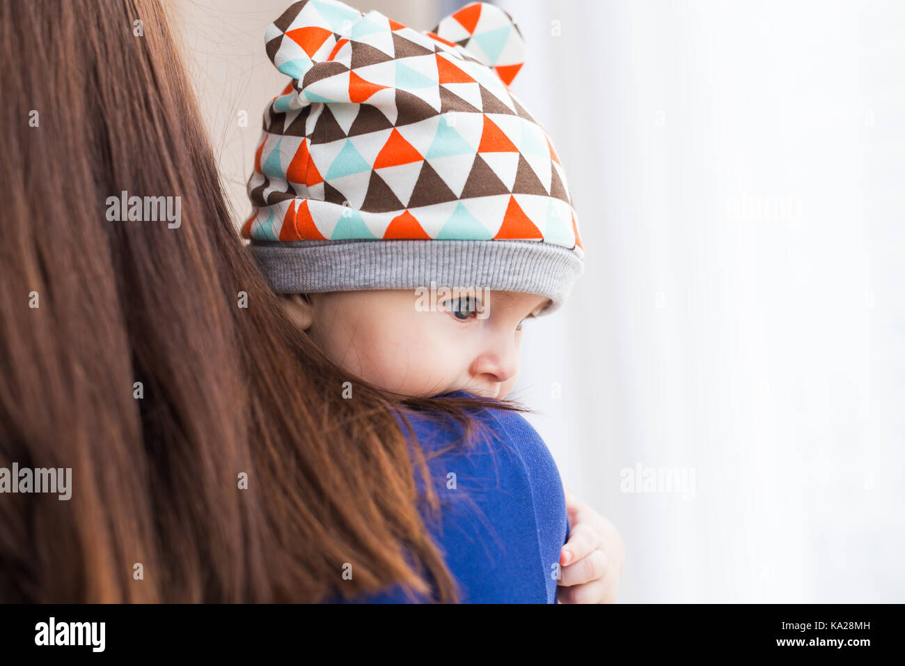 Young mother holding her little baby, back view Stock Photo - Alamy