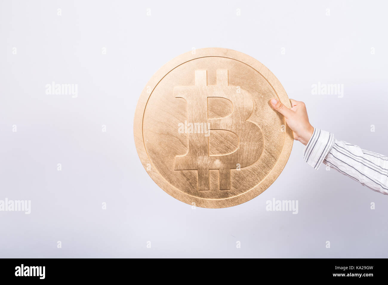 Big bitcoin in hand on white background Stock Photo - Alamy