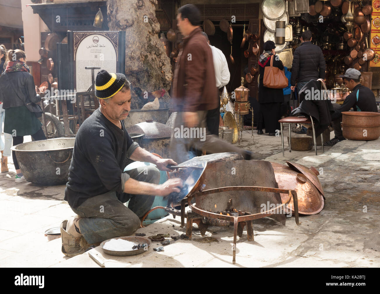 A blacksmith at work in a square in the medina - Fes, Morocco Stock ...