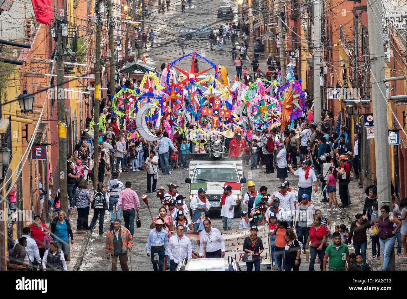Railroad workers lead a fiesta procession through the city at the start ...