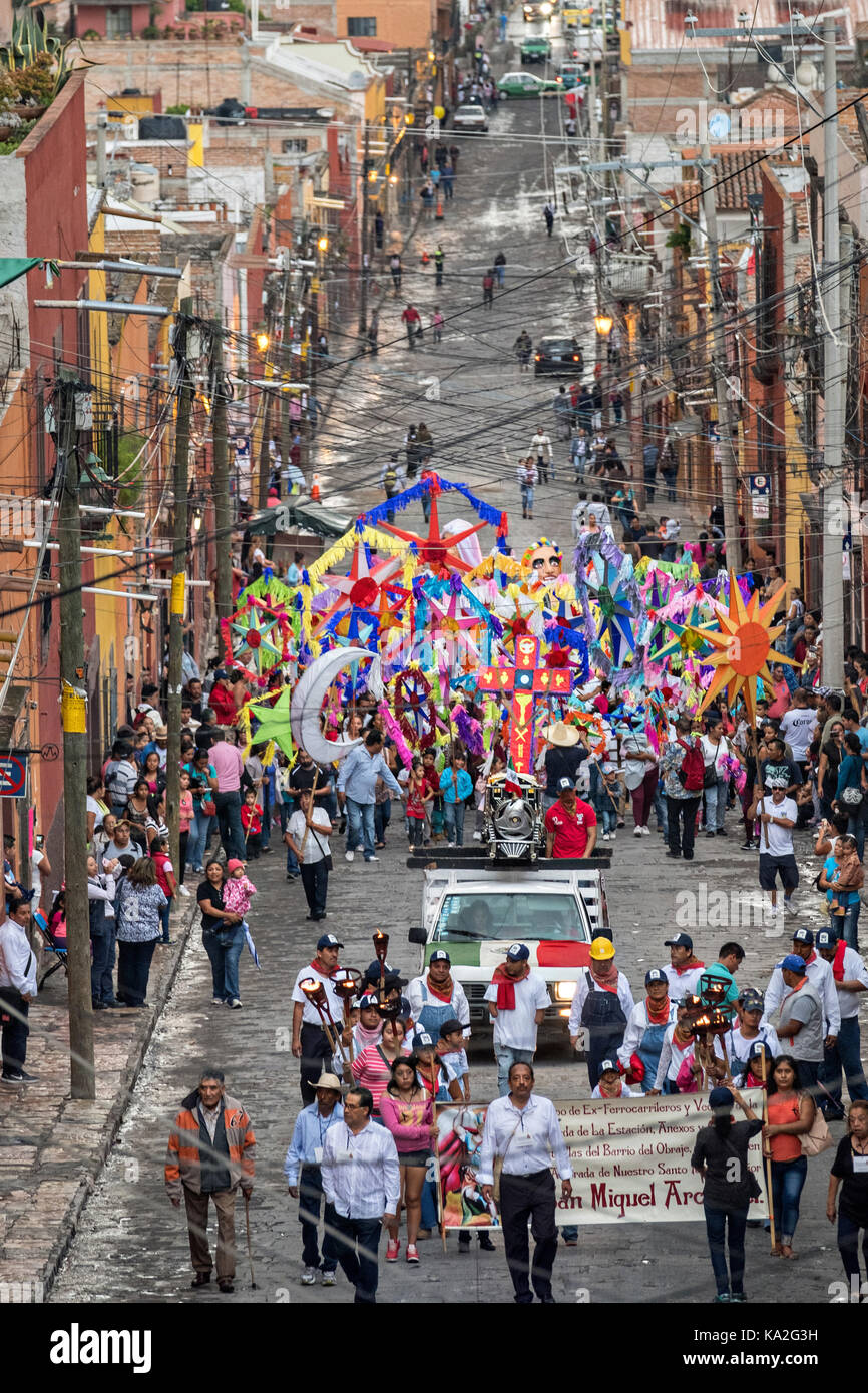 Railroad workers lead a fiesta procession through the city at the start ...