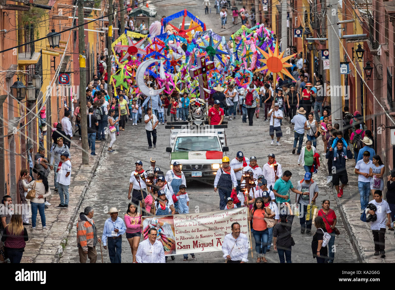Railroad workers lead a fiesta procession through the city at the start ...