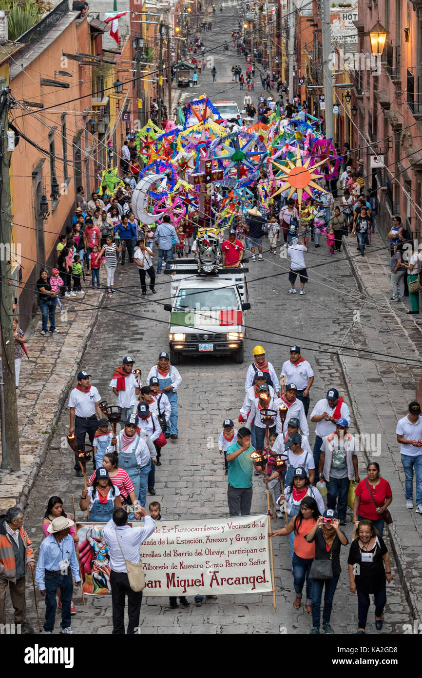 Railroad workers lead a fiesta procession through the city at the start ...