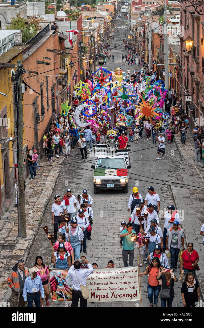 Railroad workers lead a fiesta procession through the city at the start ...
