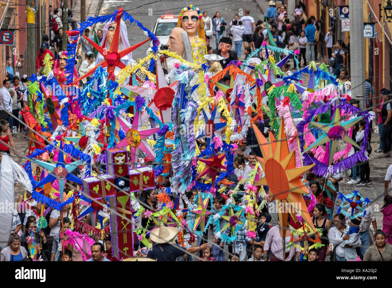 Railroad workers lead a fiesta procession through the city at the start ...
