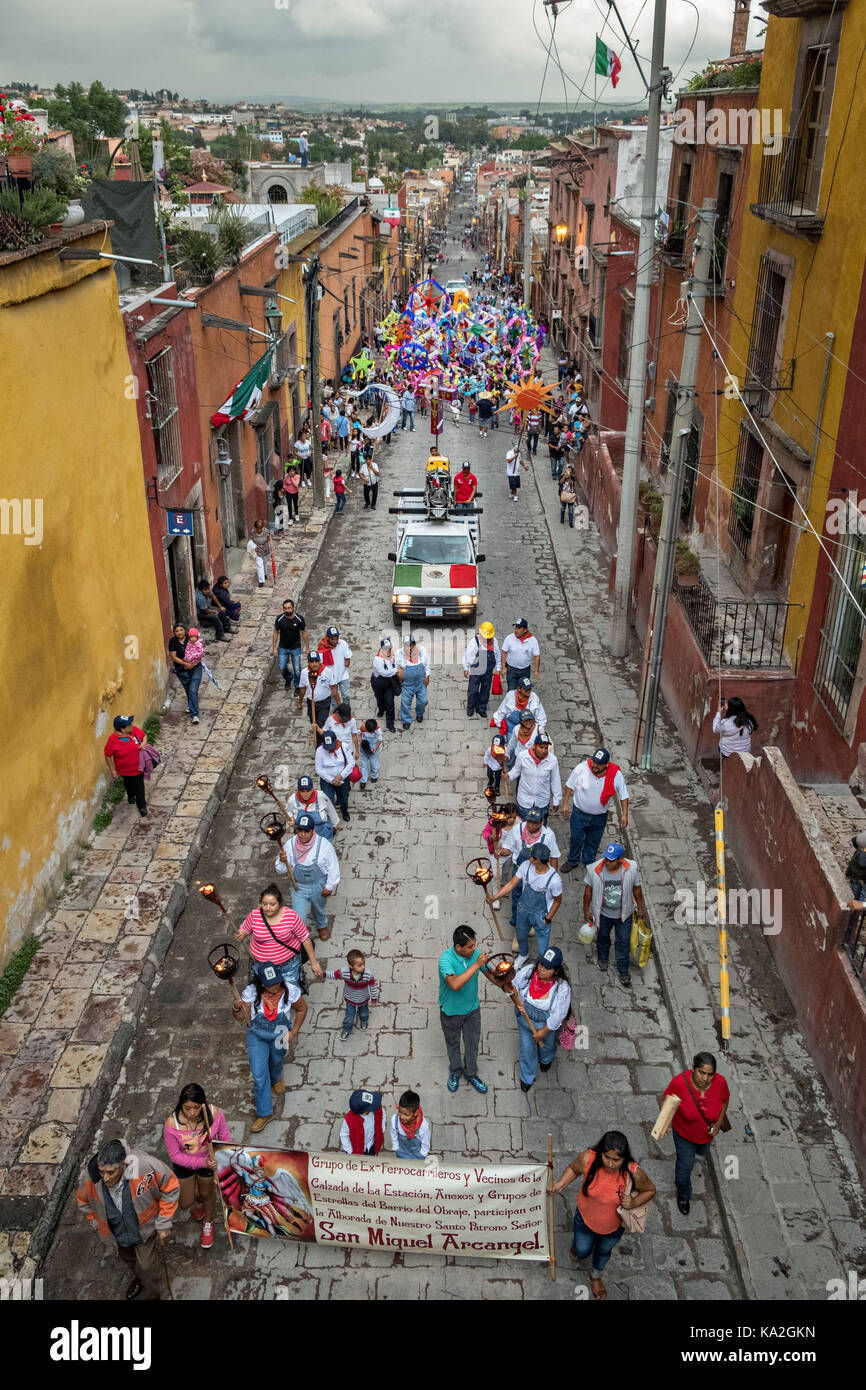 Railroad workers lead a fiesta procession through the city at the start ...