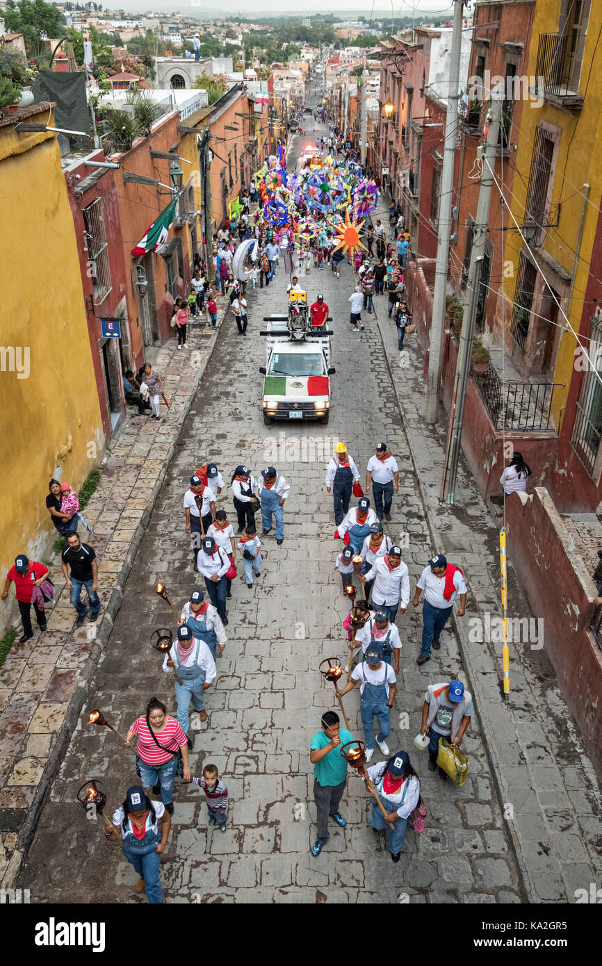 Railroad workers lead a fiesta procession through the city at the start ...